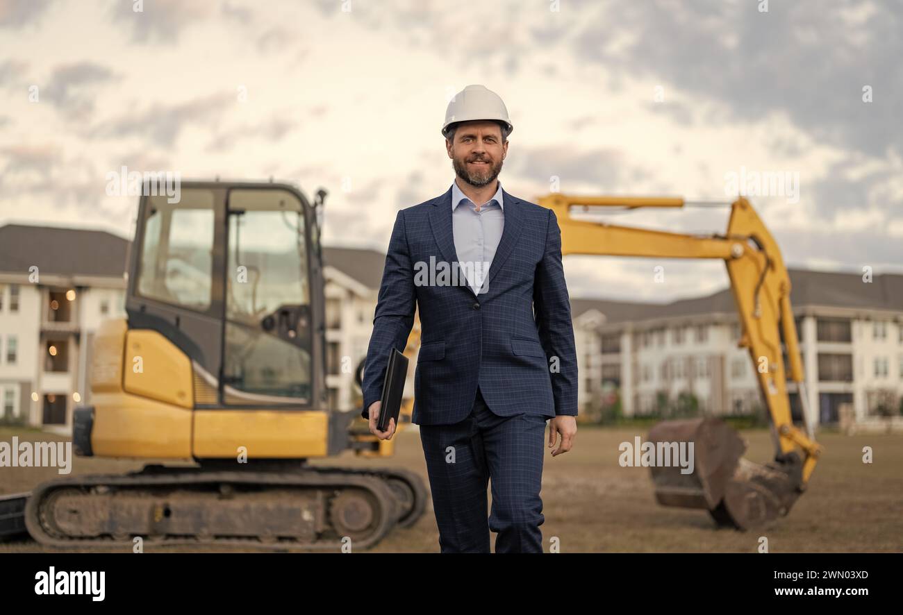 glad businessman with building plan. businessman check building plan at ...