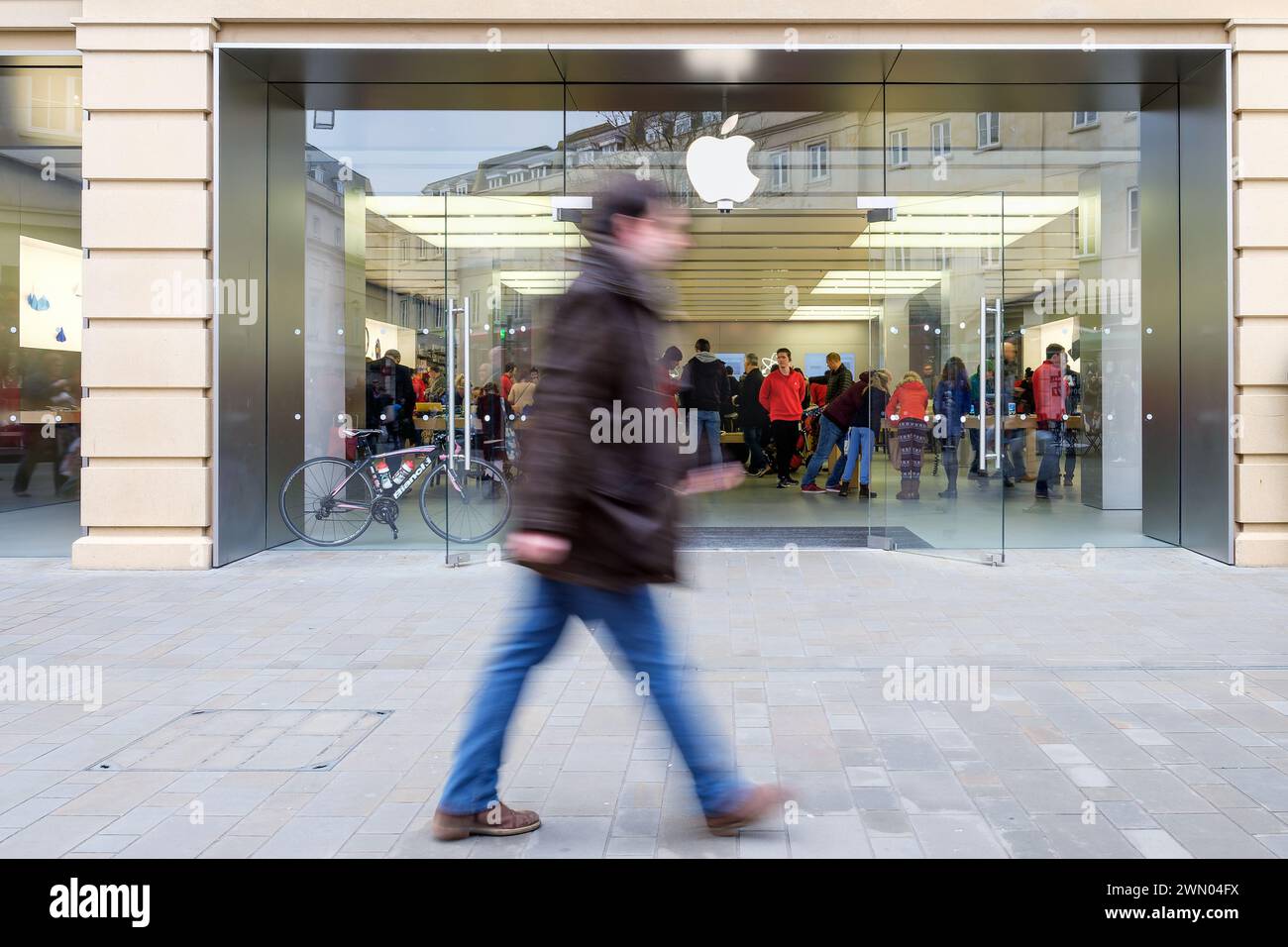 Shoppers are pictured walking past an apple store / shop in Bath ...