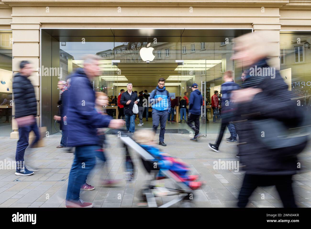 Shoppers are pictured walking past an apple store / shop in Bath ...