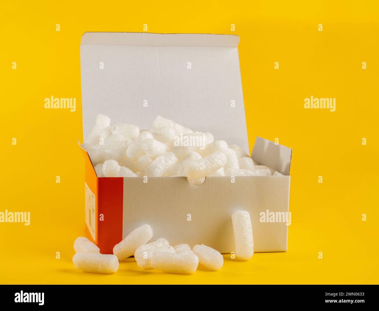 White packing peanuts in a cardboard packing carton isolated on a ...