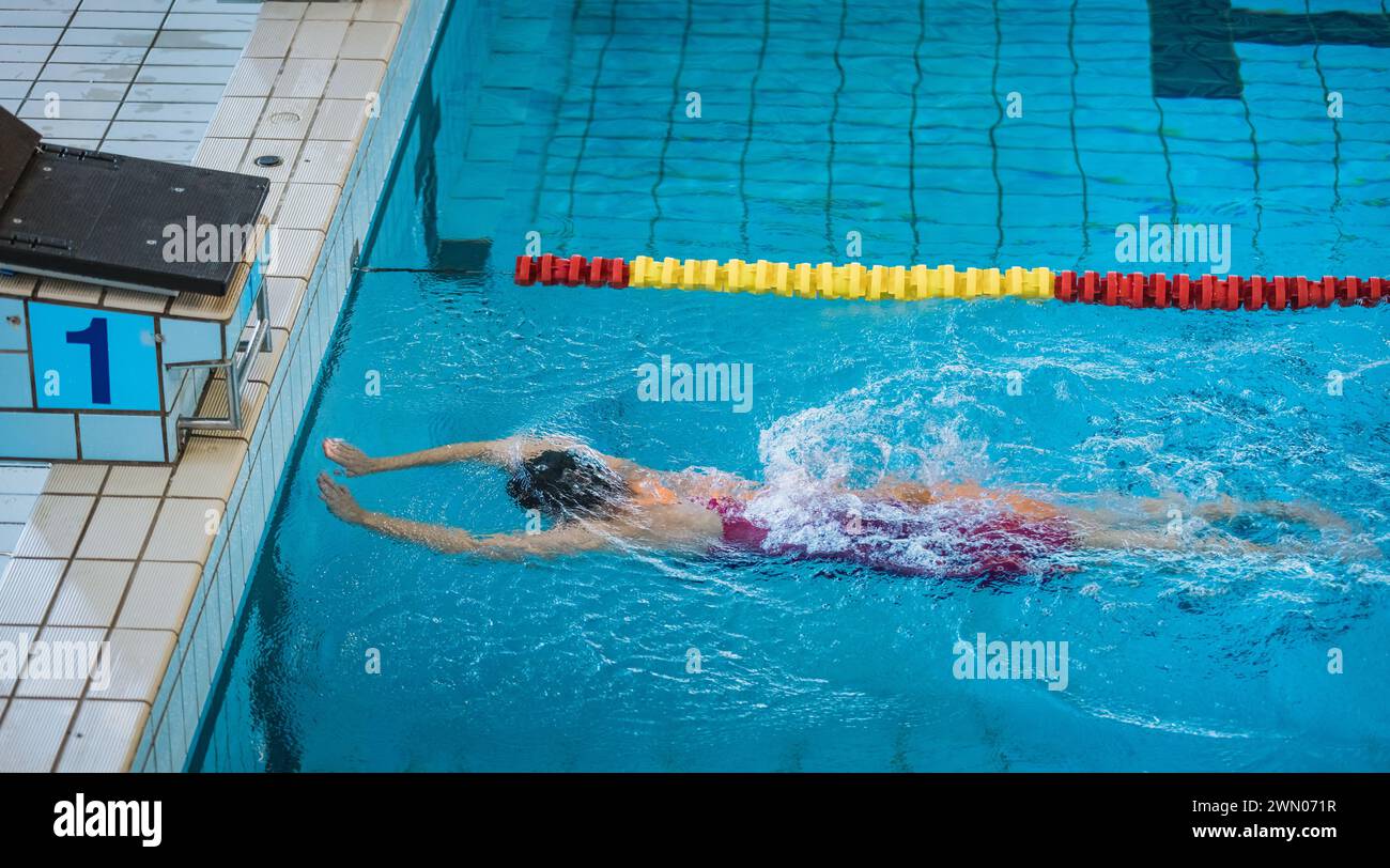Professional sportswoman, a swimmer during freestyle swimming training ...