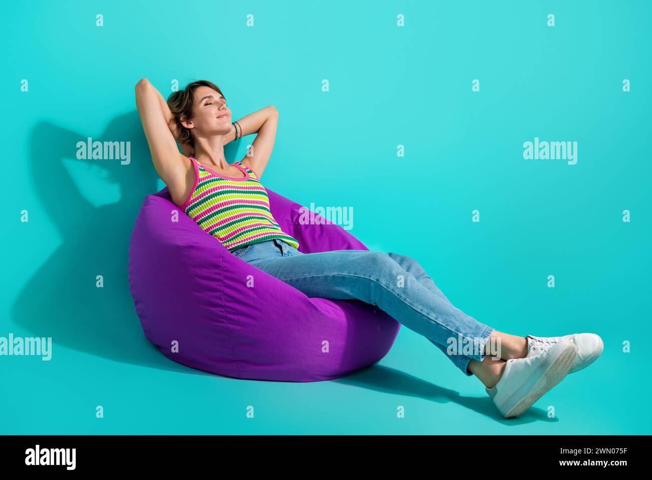 Full body portrait of peaceful carefree lady sit comfort bag closed ...