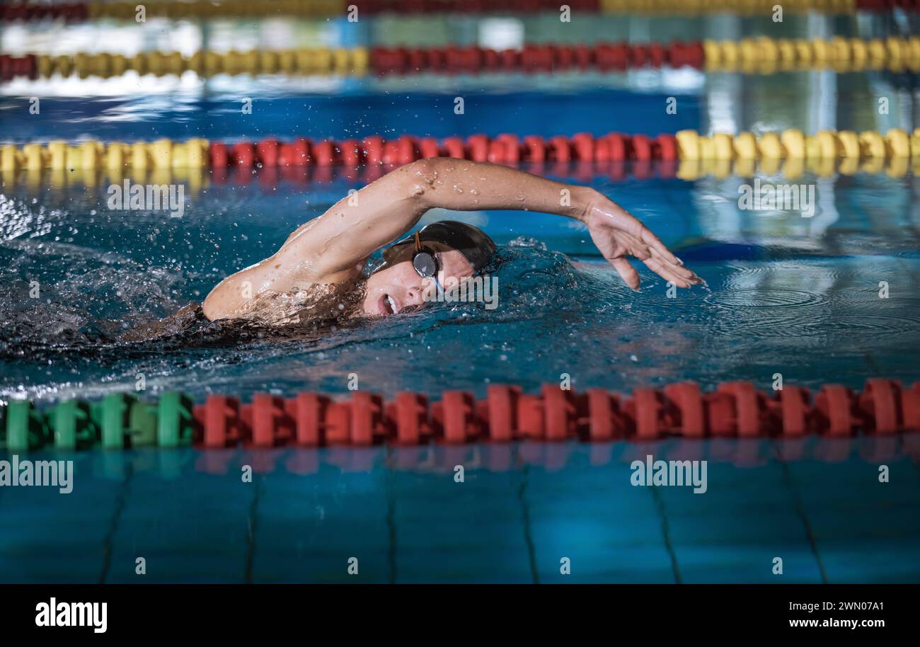 Professional female swimmer swimming the front crawl stroke. Freestyle ...
