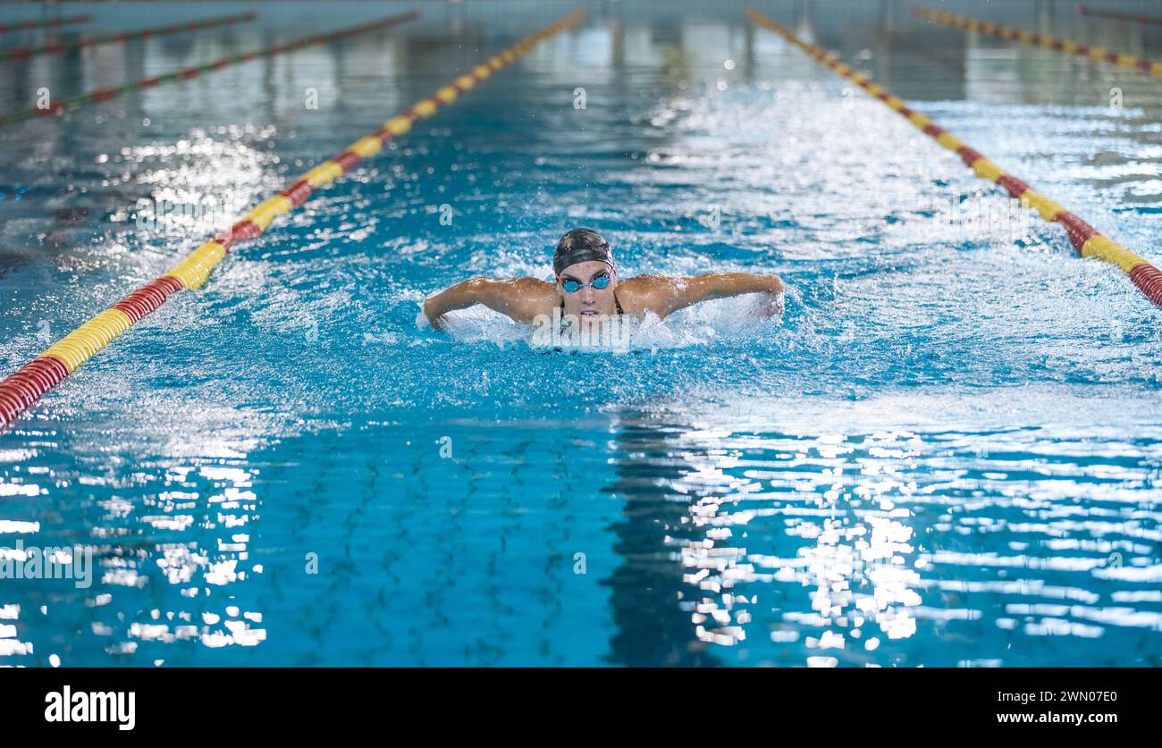 Front view of a powerful elite female swimmer competitor performing ...