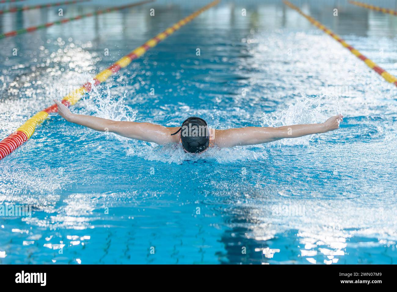 Female competitive swimmer moving through the water performing the ...