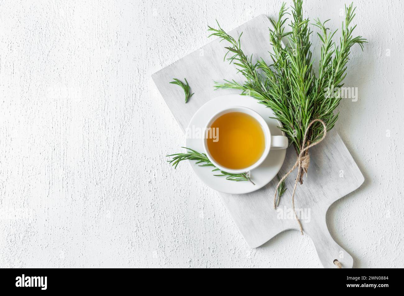 Glass cup of healthy rosemary tea with fresh rosemary bunch on rustic ...