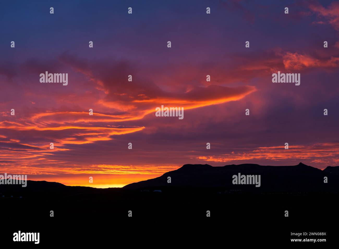 Amazing midnight sunset in Iceland with dark mountain silhouettes on ...