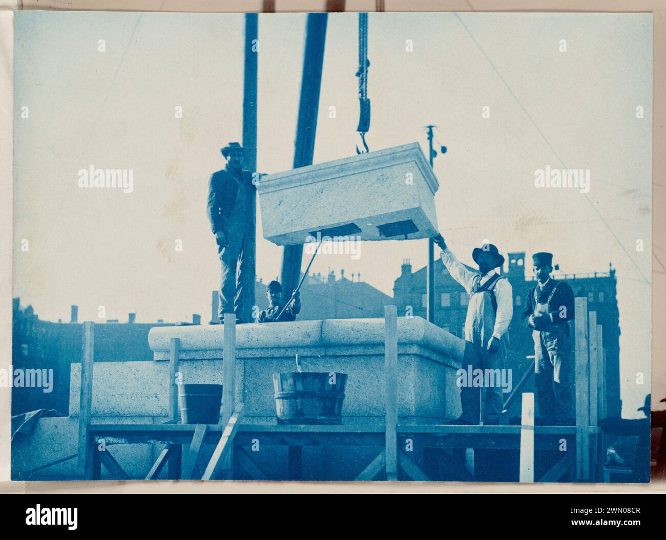 Workmen laying the cornerstone, construction of the McKim Building ...