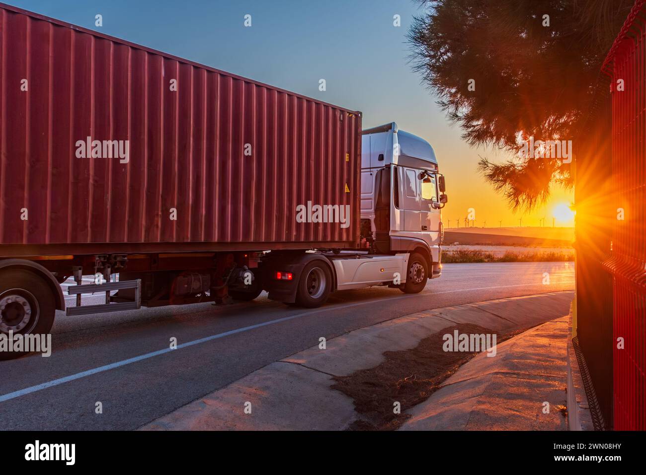 Truck with a semi-trailer with a maritime container driving on a ...