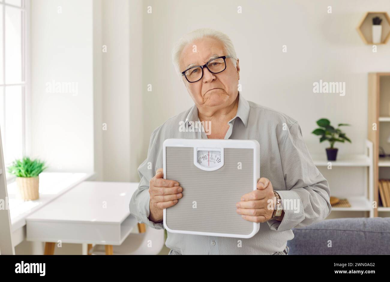 Fit man standing scale in hi-res stock photography and images - Alamy