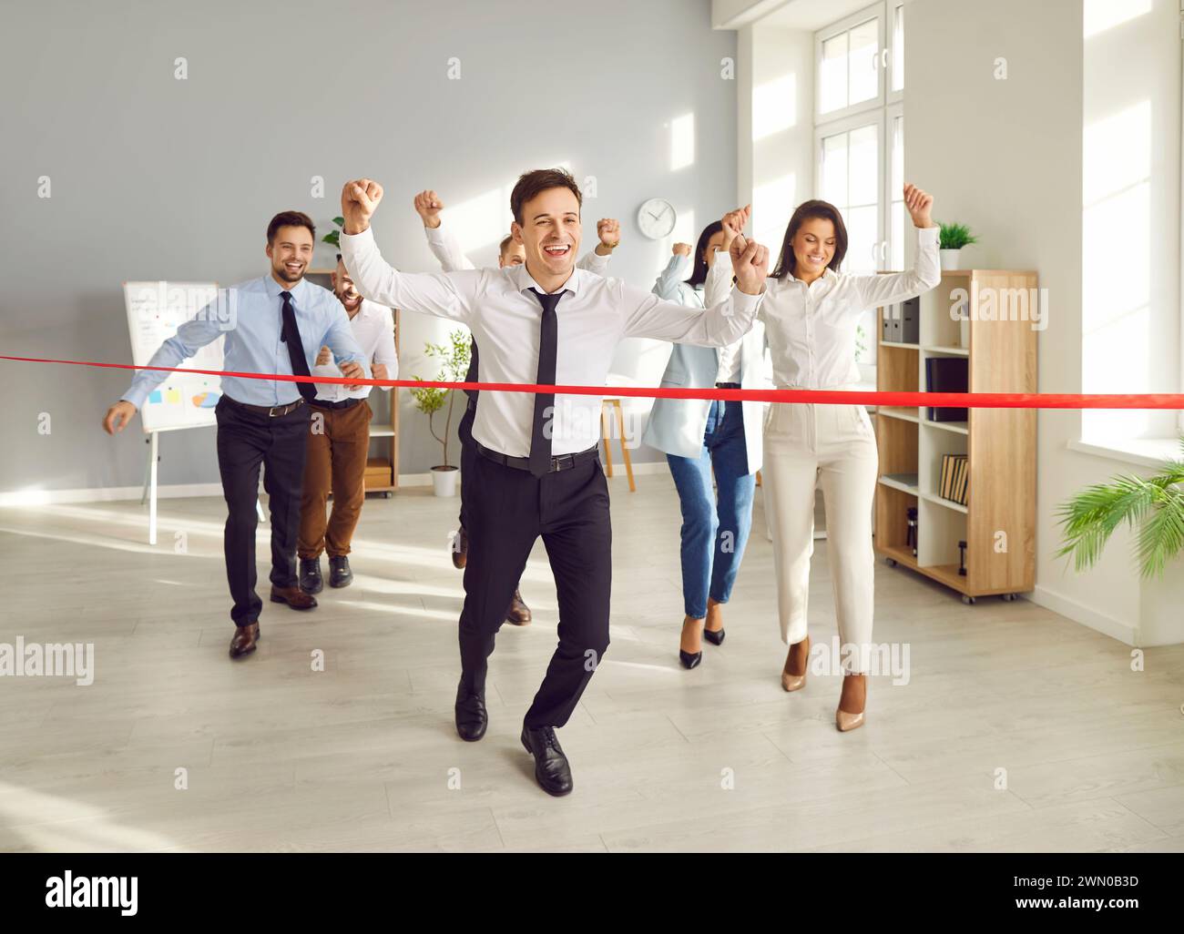 Business people having fun organizing a race during meeting competing ...