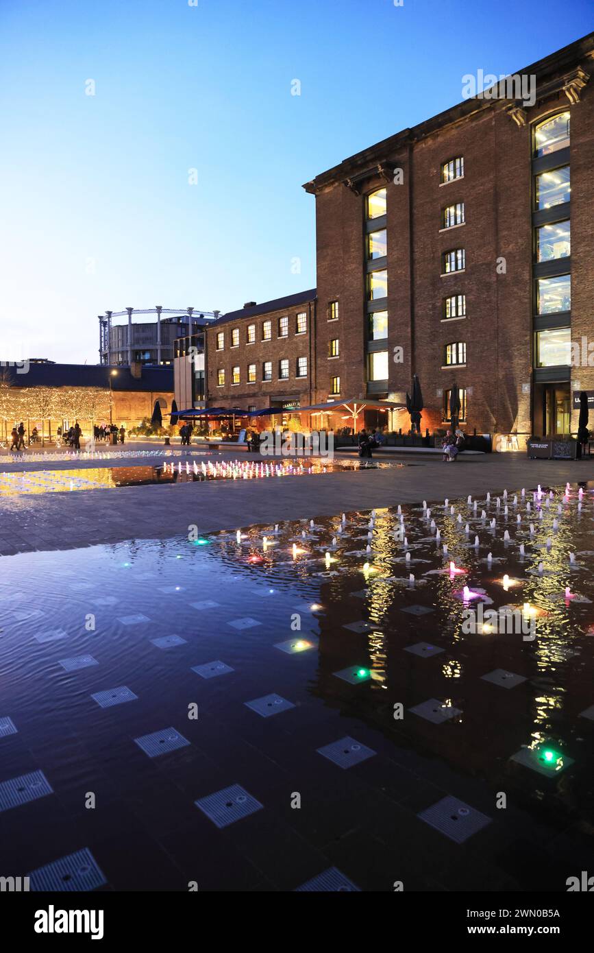 The coloured fountains in Granary Square at twlight in winter, at Kings ...