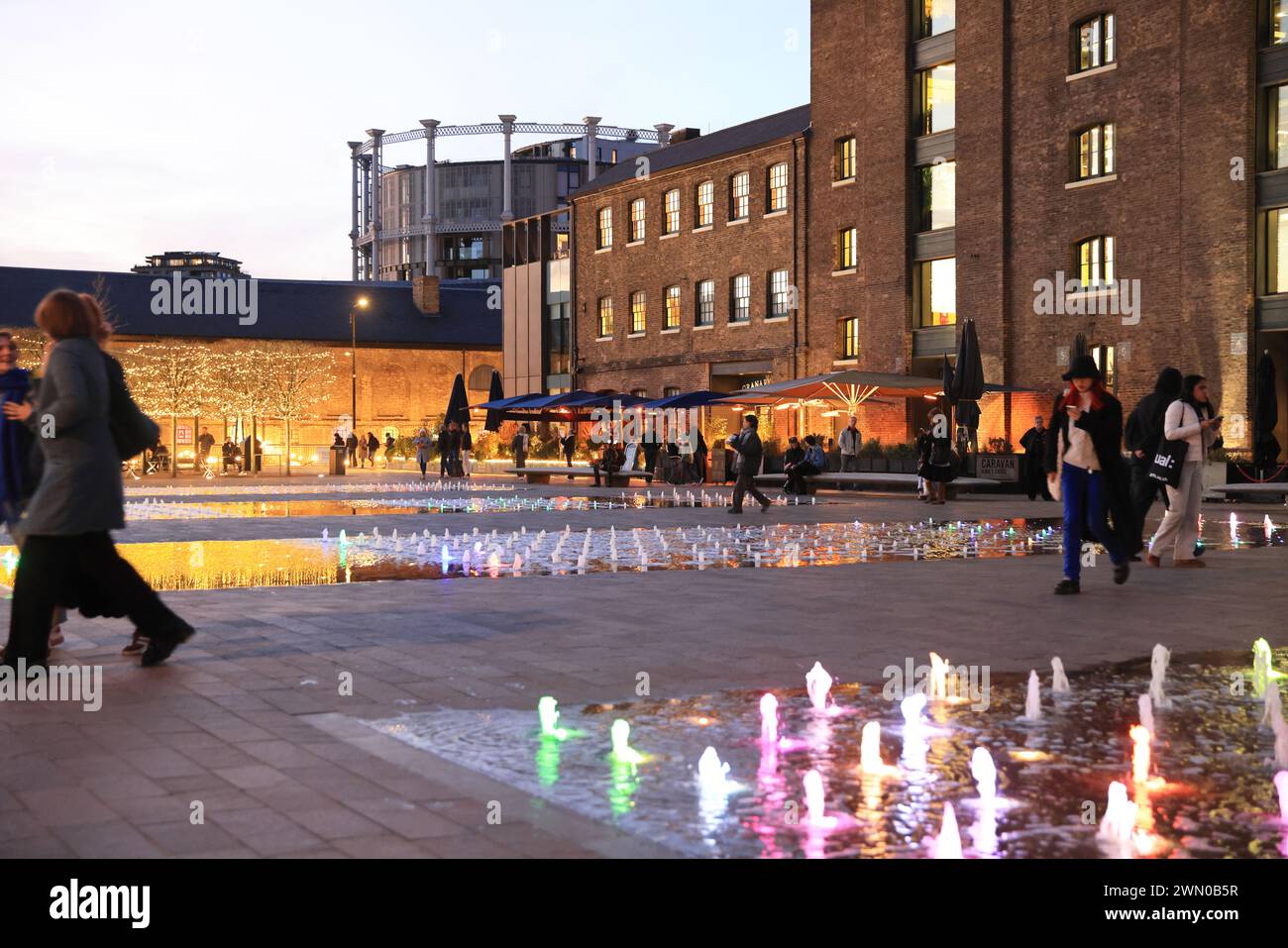 The coloured fountains in Granary Square at twlight in winter, at Kings ...