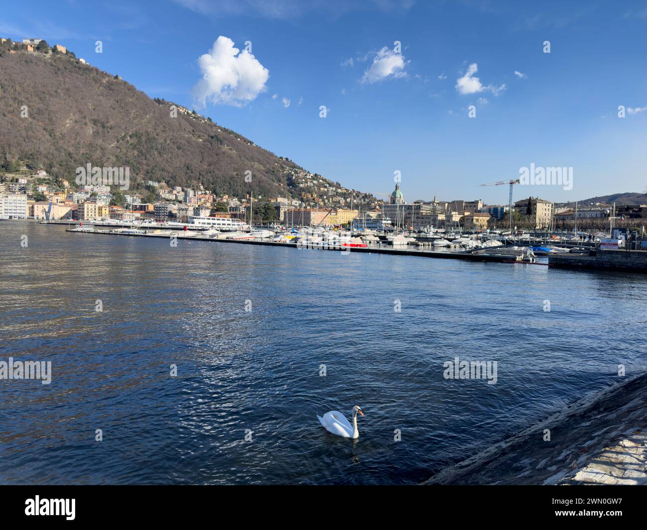 a beautiful view of the boats harboured in the Lake Como, CO, Lombardy ...