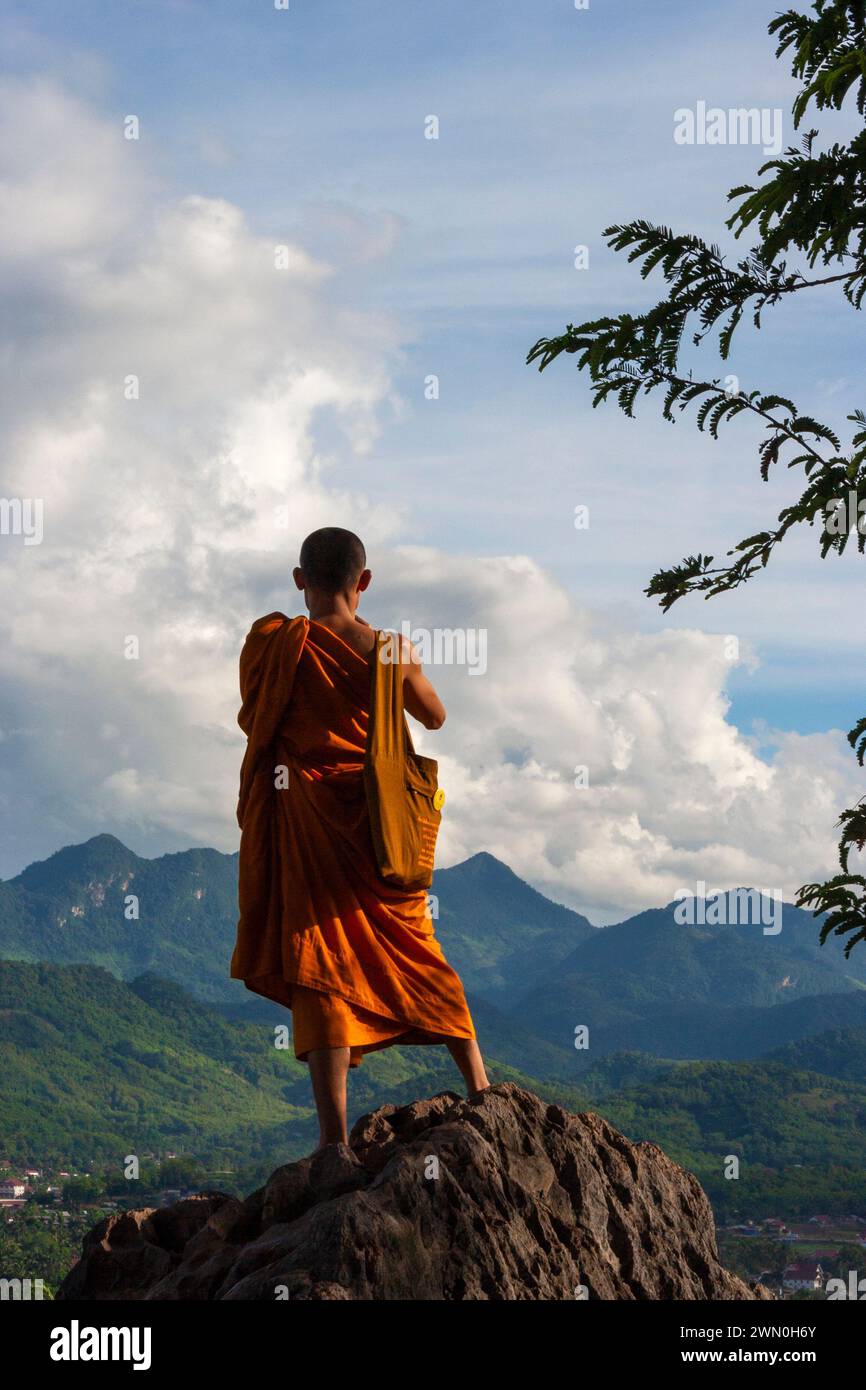 Buddhist monk standing on the peak of Phou Si hill in Luang Prabang in ...
