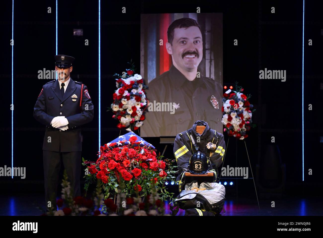 A photograph of firefighter-paramedic Adam Finseth, 40, stands over his ...