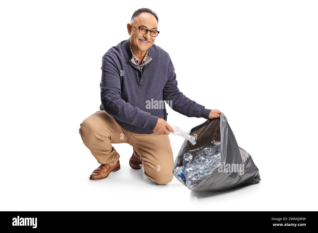 Mature man collecting plastic bottles in a waste bag isolated on white ...