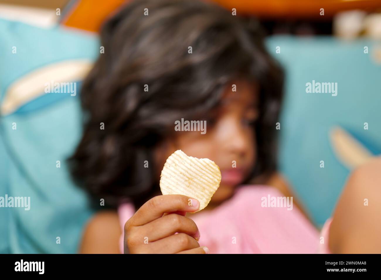 A close-up photo of a young girl with a content expression, enjoying a ...
