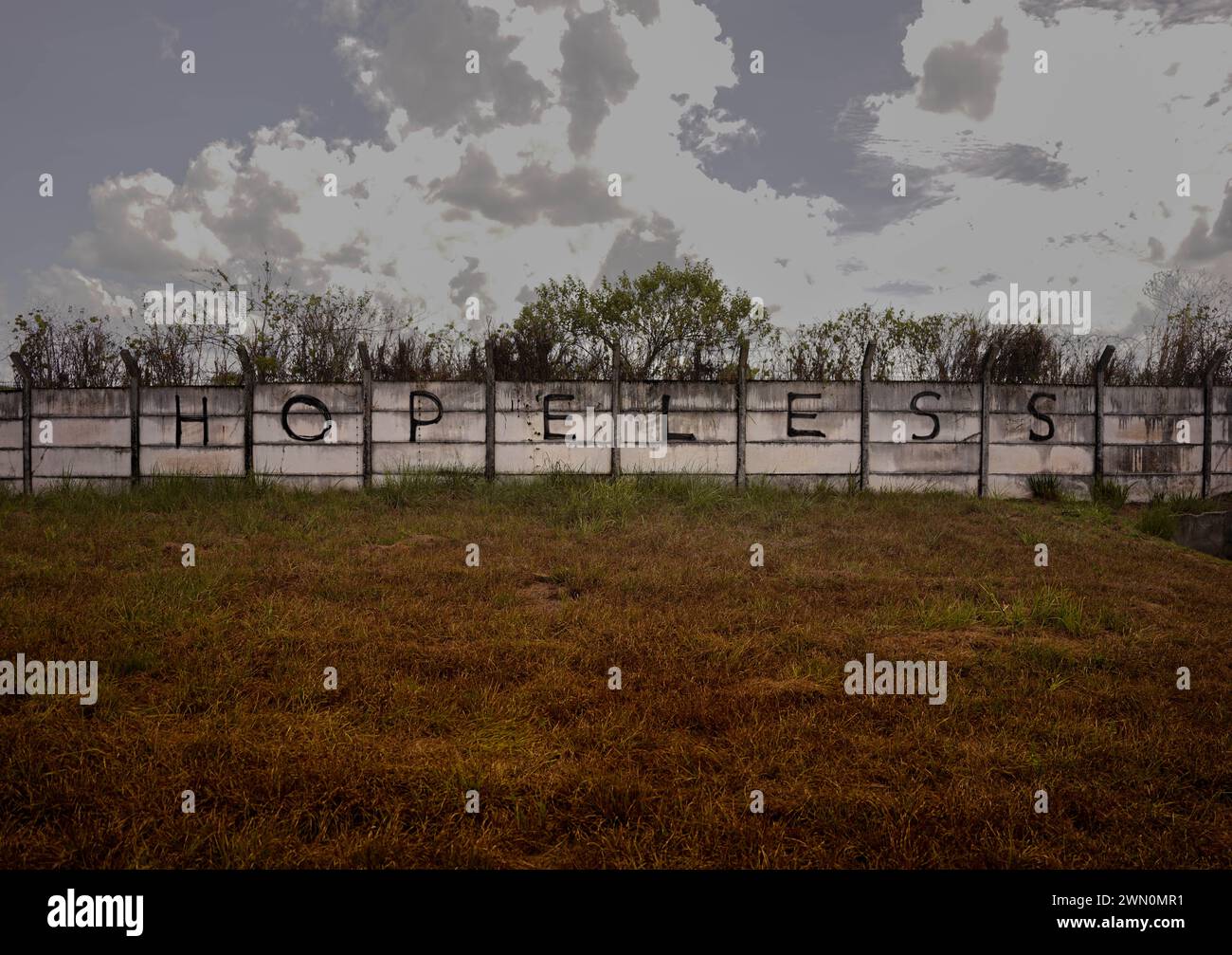 concrete enclosure with barbed wire Stock Photo - Alamy