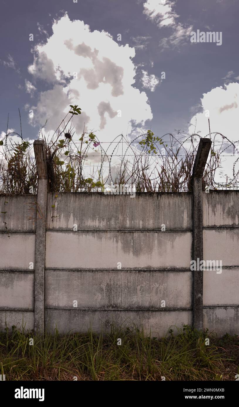 concrete enclosure with barbed wire Stock Photo - Alamy