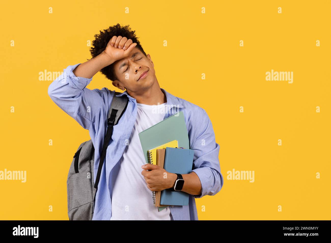 Stressed black student guy with books, overwhelmed by study load Stock ...