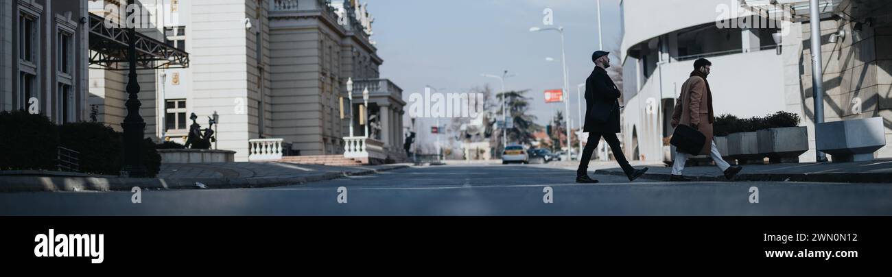 Urban scene with two people walking by elegant architecture on a sunny ...