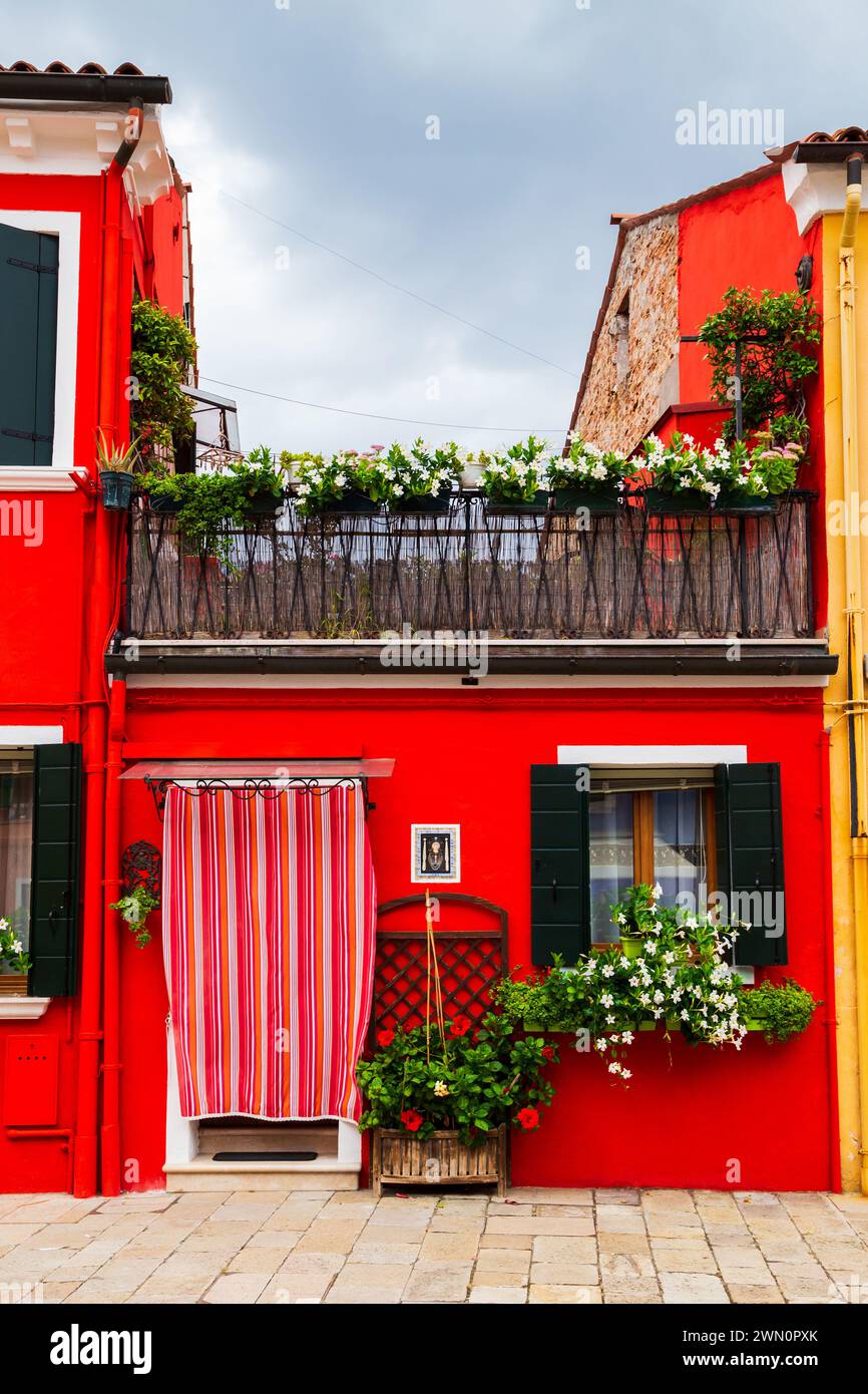 Bright traditional red house on Burano island, Venice, Italy. Colorful ...