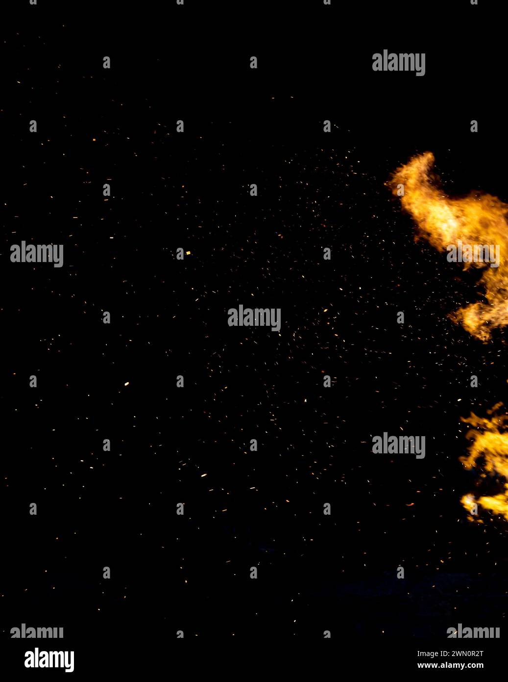Flying sparks on the background of fire. Flames of fire with sparks in ...