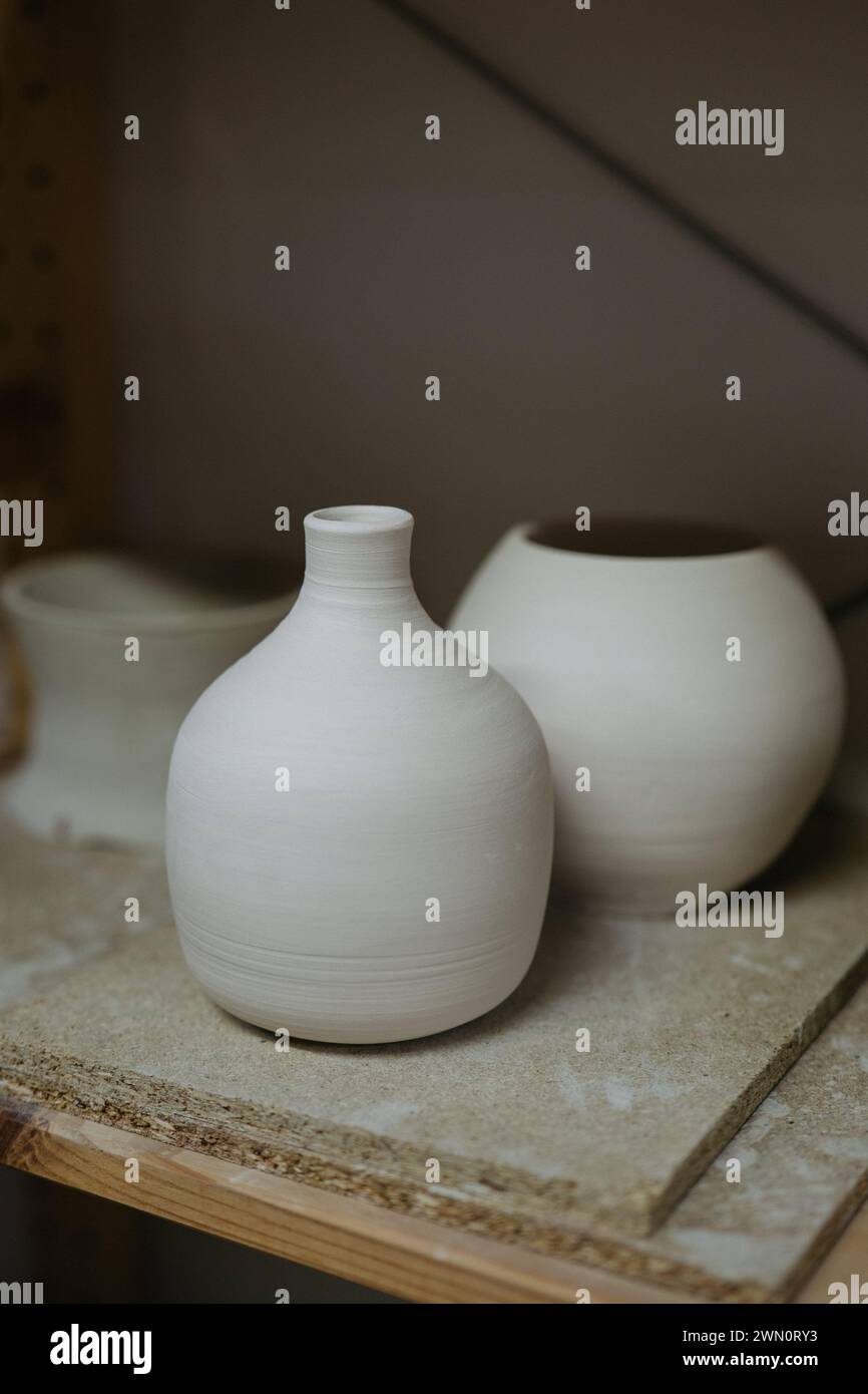 Unfinished White Ceramic Vases on a Shelf Reflecting the Process of ...