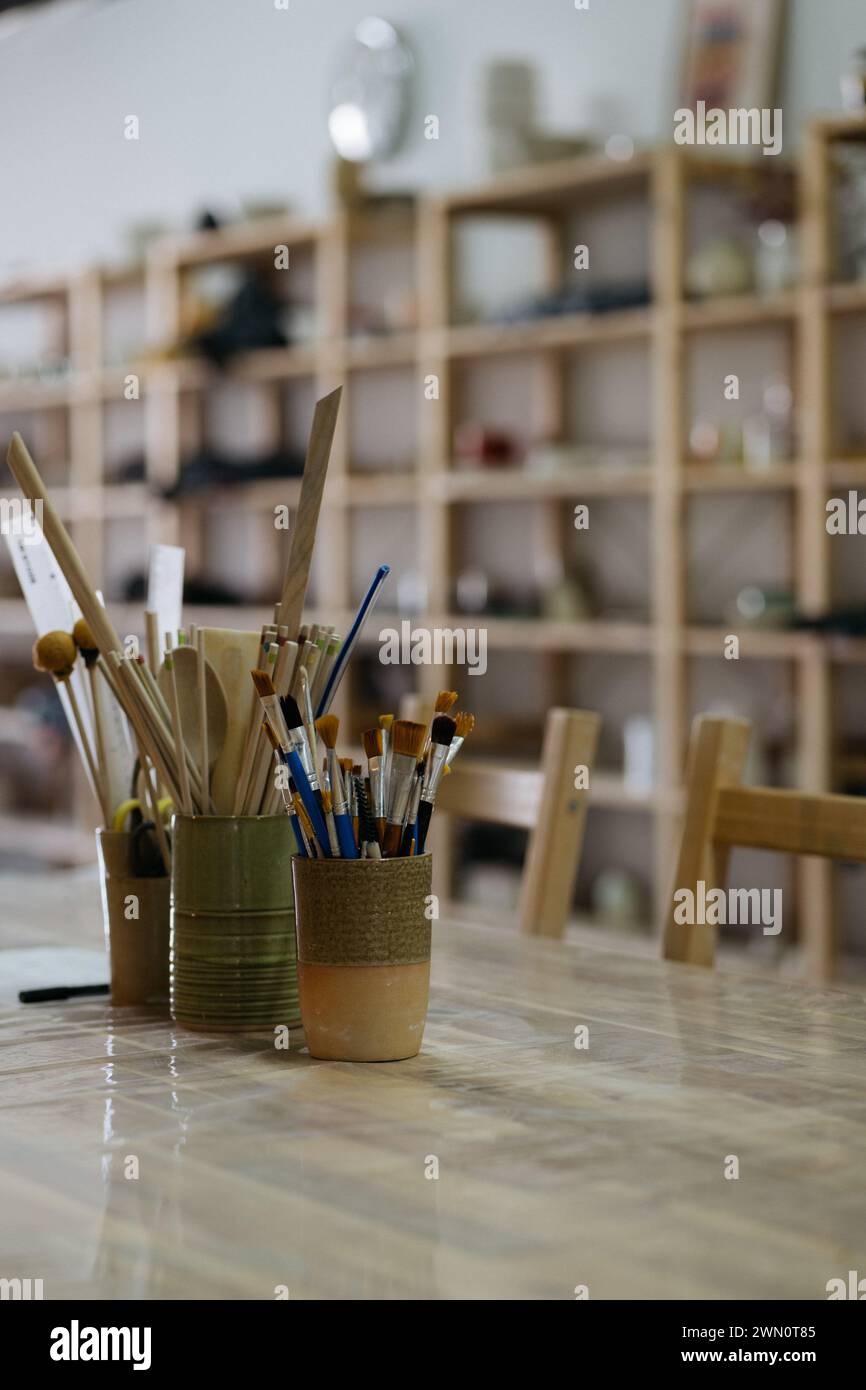 Artistic Pottery Studio Interior with Ceramic Tools and Brushes on a ...