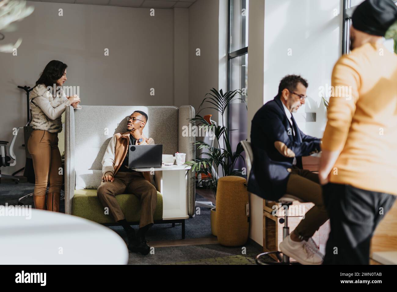 A diverse group of business professionals collaborating and discussing ...