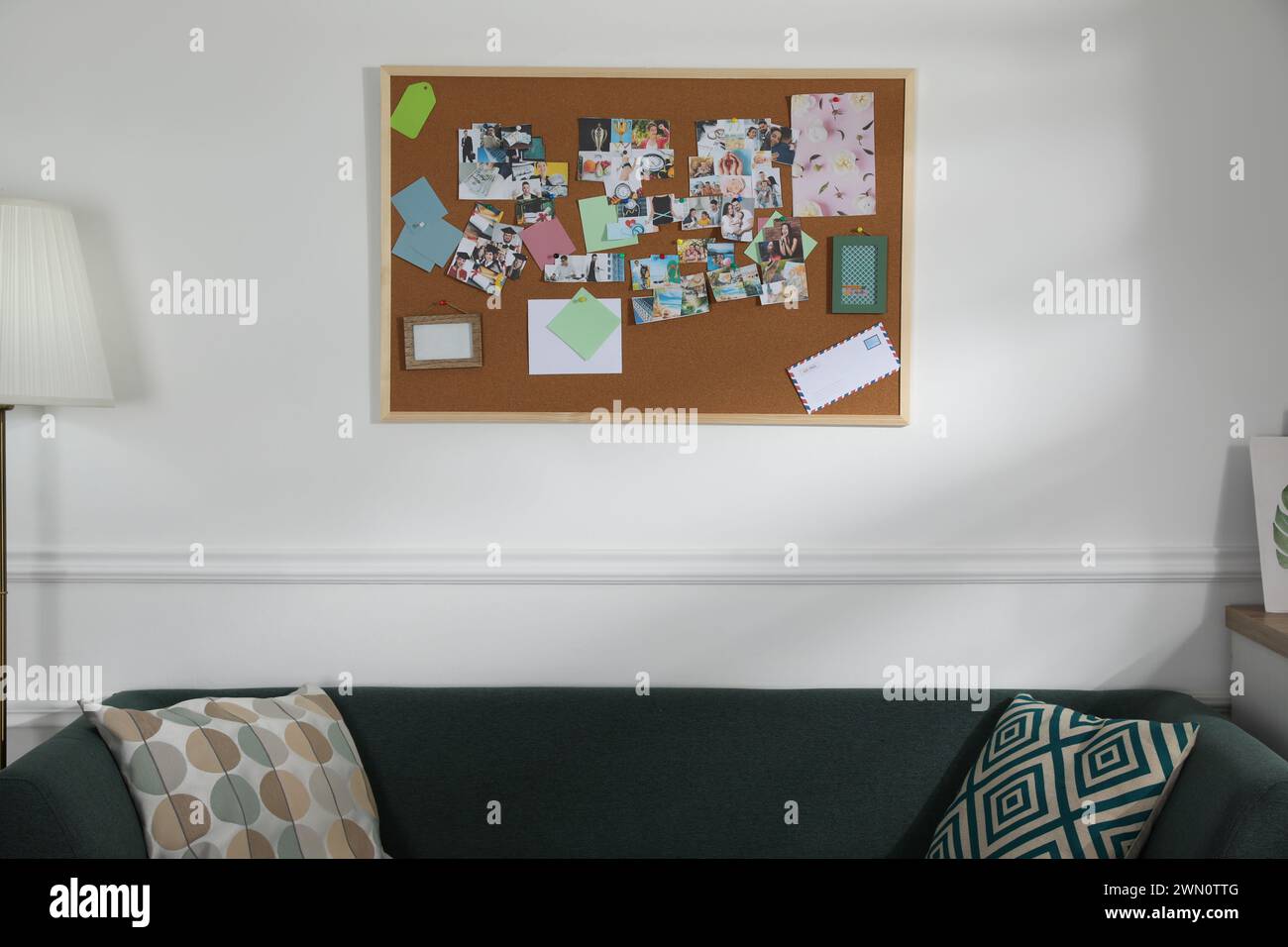 Stylish living room interior with vision board and sofa Stock Photo - Alamy