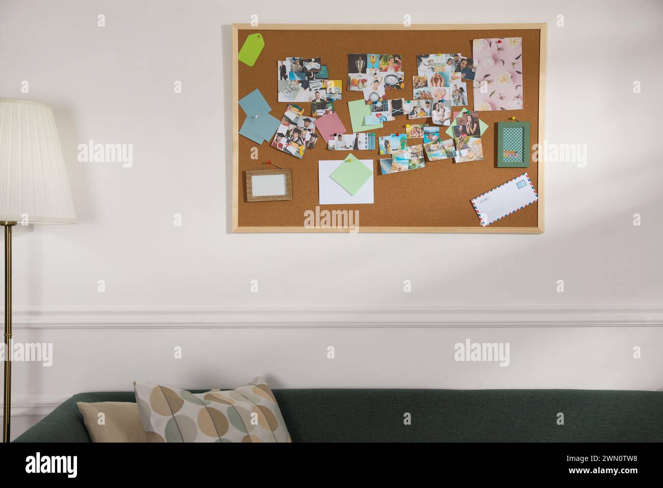 Stylish living room interior with vision board and sofa Stock Photo - Alamy