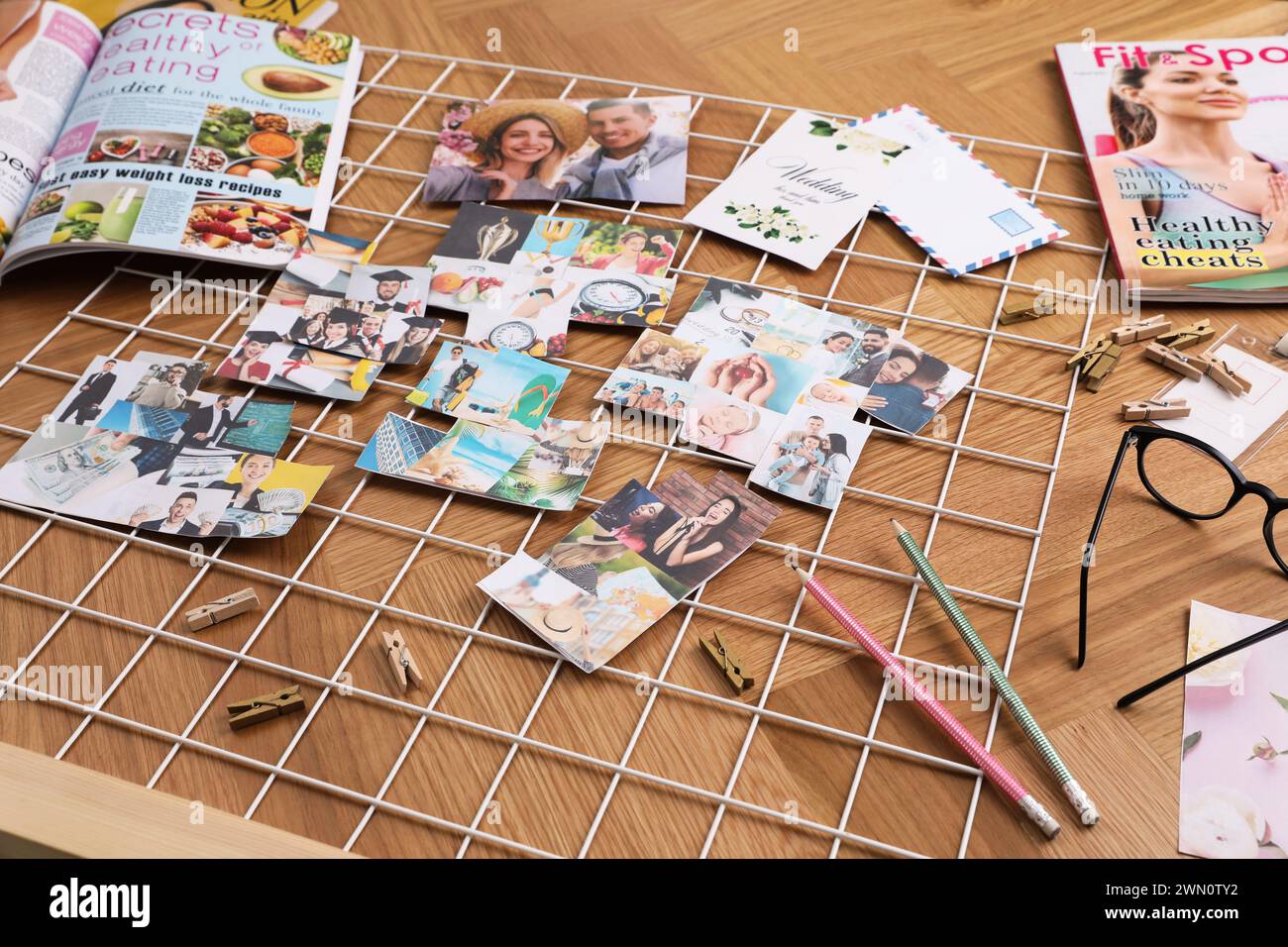 Composition with different photos, magazines, stationery and metal grid ...
