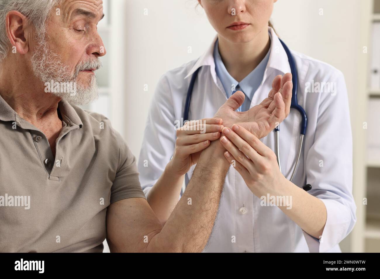 Arthritis symptoms. Doctor examining patient's hand in hospital Stock ...