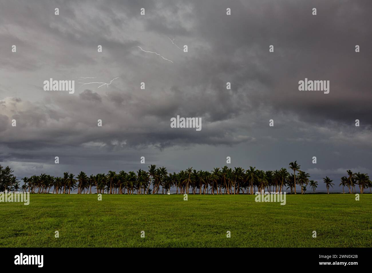 Lightning through the storm clouds from Asan Beach Park, Guam Stock ...
