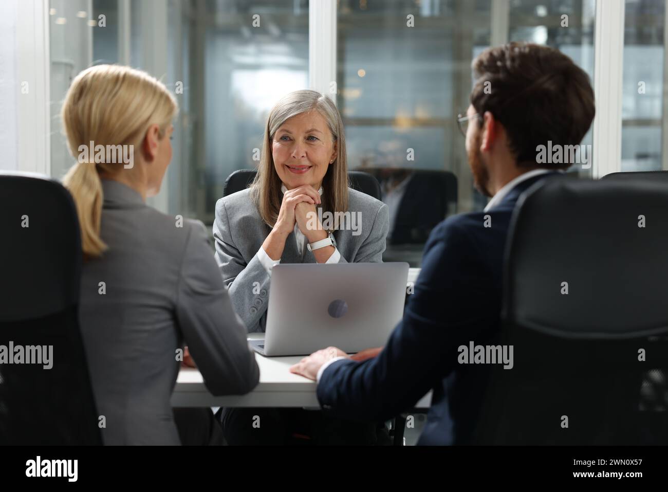 Lawyer working with clients at table in office Stock Photo - Alamy