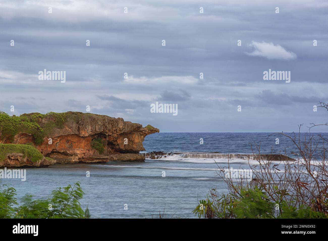 Jagged rocky coastline of Inarajan as a storm rolls in on Guam Stock ...