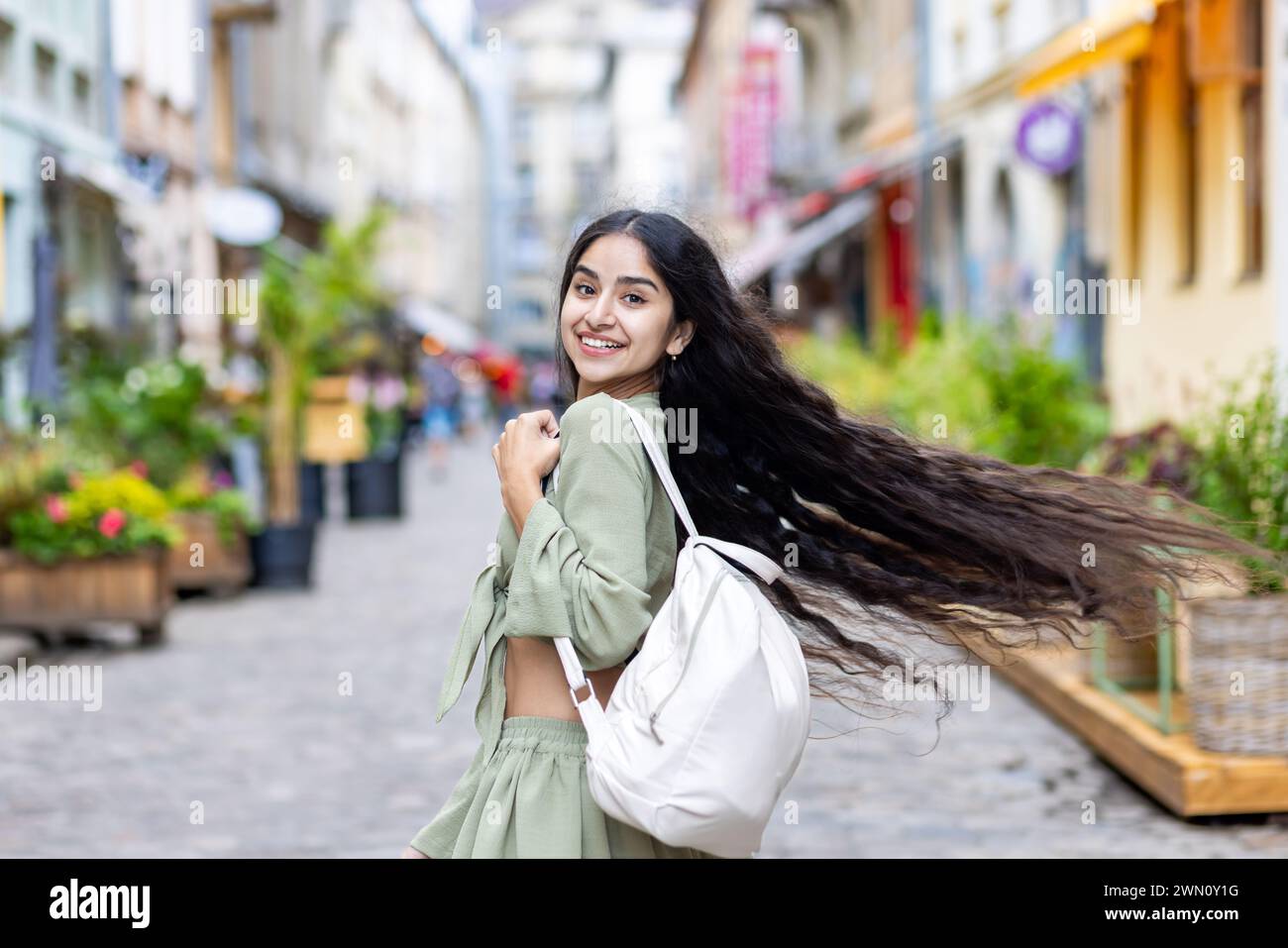 Photo of happy smiling Indian young girl walking, running looking back ...