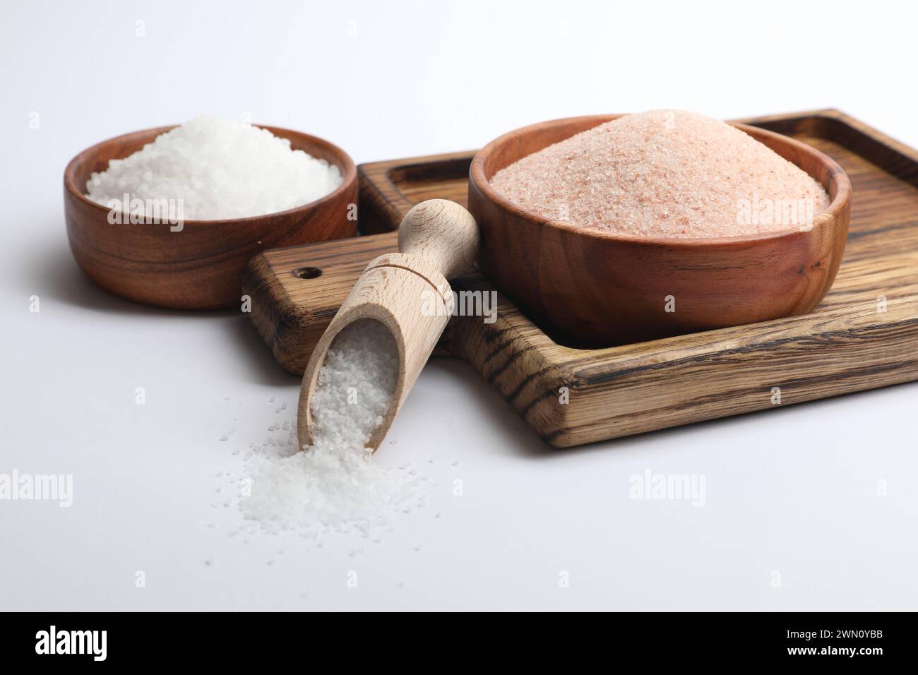 Different types of natural salt on white background Stock Photo - Alamy