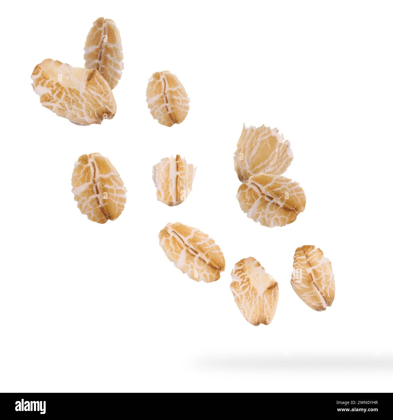Rolled oat flakes falling on white background Stock Photo - Alamy
