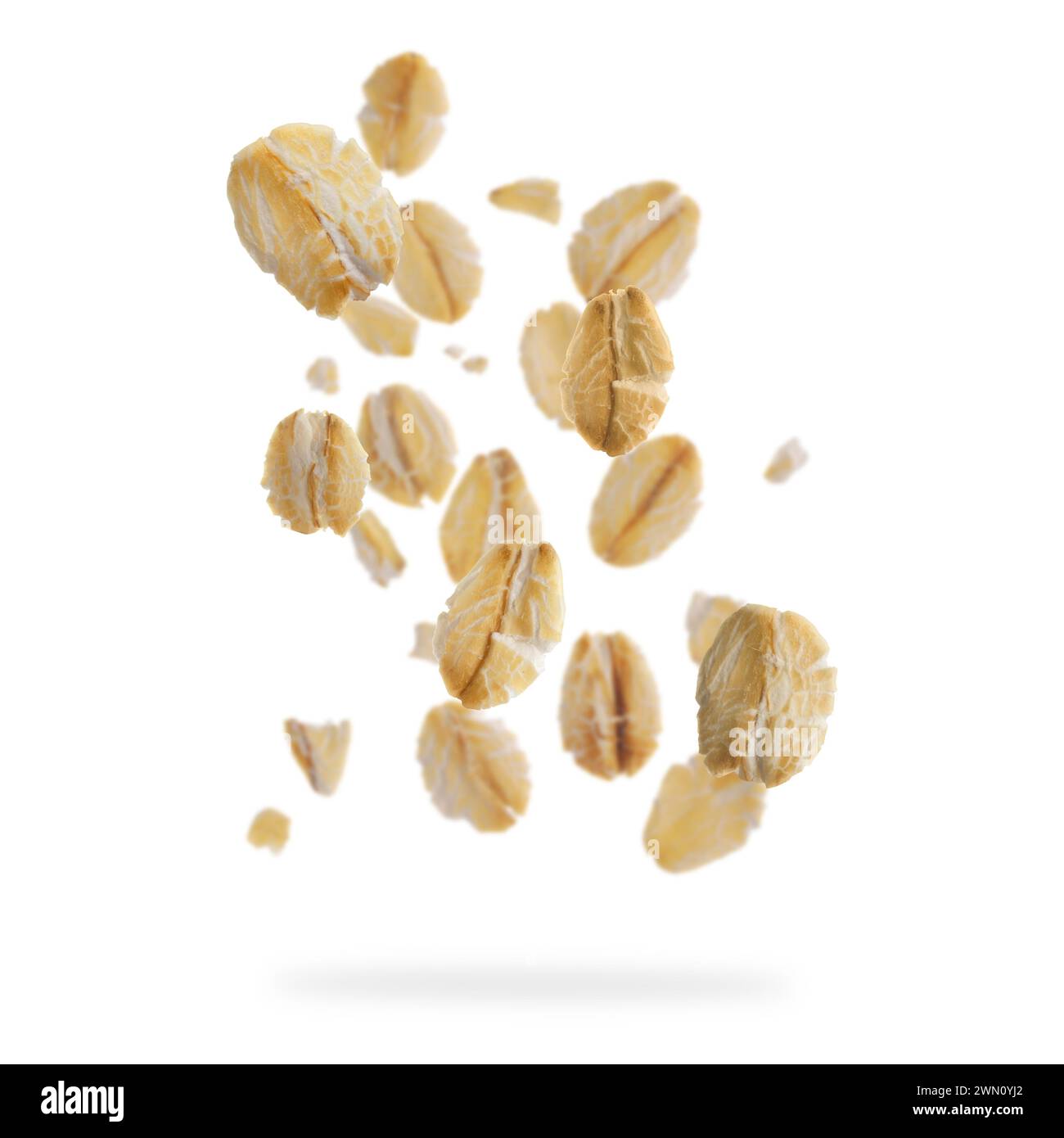 Rolled oat flakes falling on white background Stock Photo - Alamy
