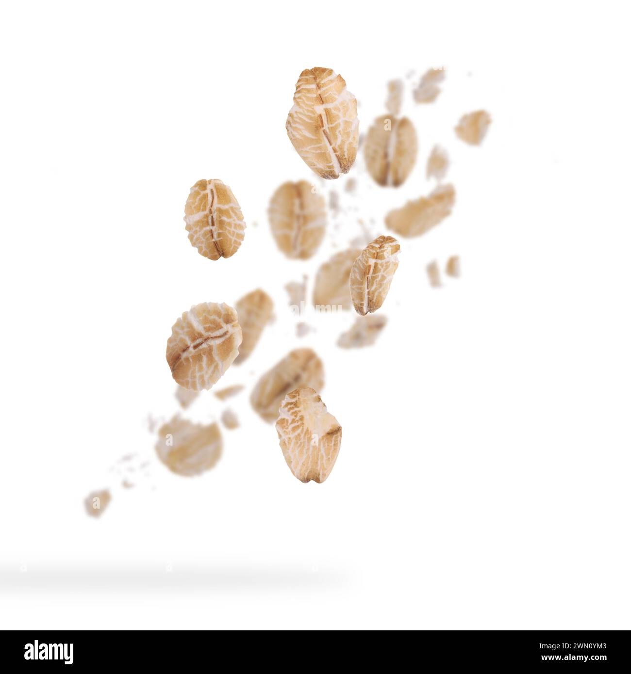 Rolled oat flakes falling on white background Stock Photo - Alamy