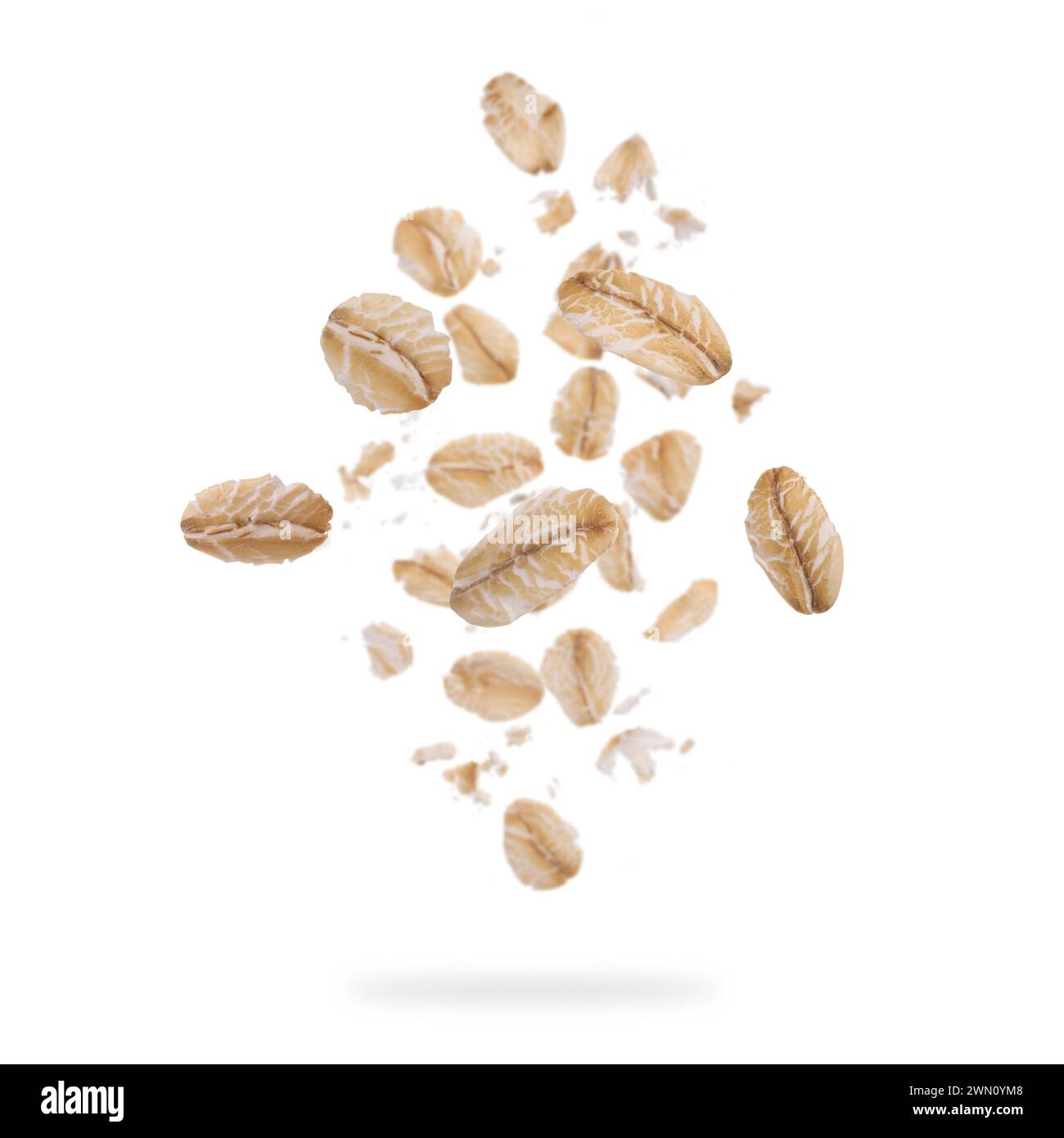 Rolled oat flakes falling on white background Stock Photo - Alamy