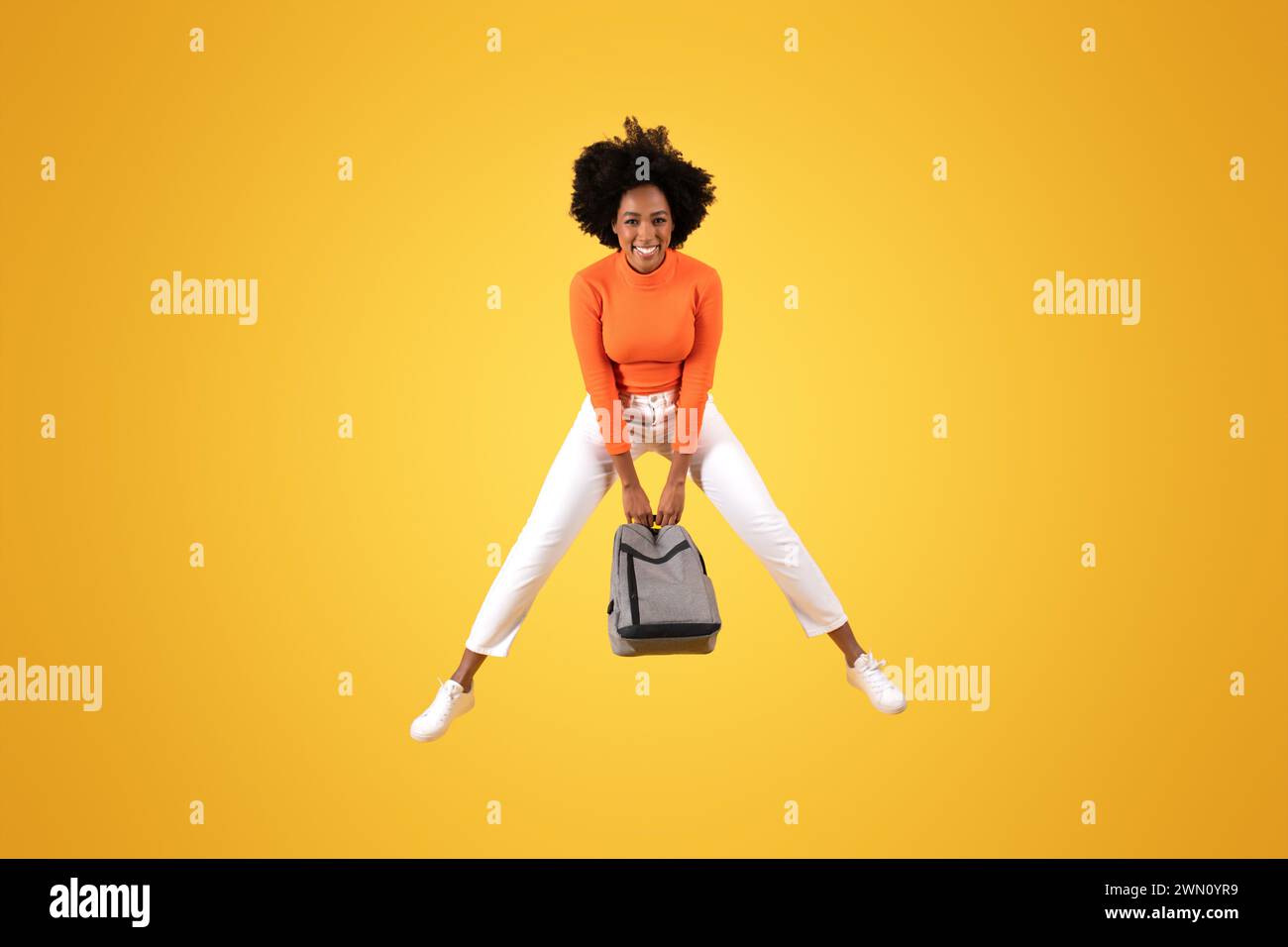 Dynamic overhead shot of a delighted young woman with afro hair ...
