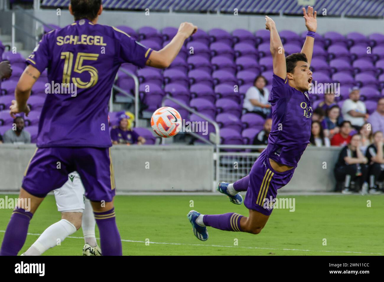 Orlando City forward Ramiro Enrique, right, flies through air going ...