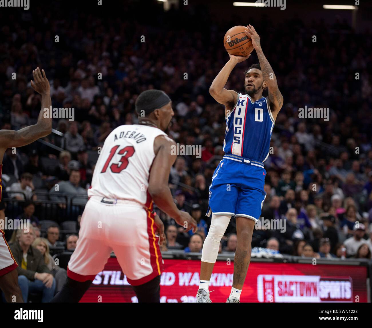 Sacramento Kings guard Malik Monk (0) shoots over Miami Heat center Bam ...