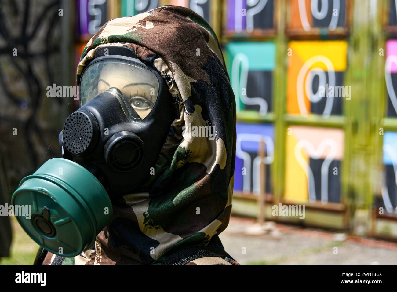 Mannequin head with gas mask and camouflage military hood Stock Photo ...