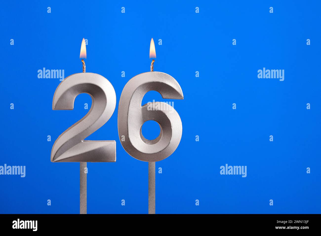 Birthday number 26 - Candle lit on blue background Stock Photo - Alamy