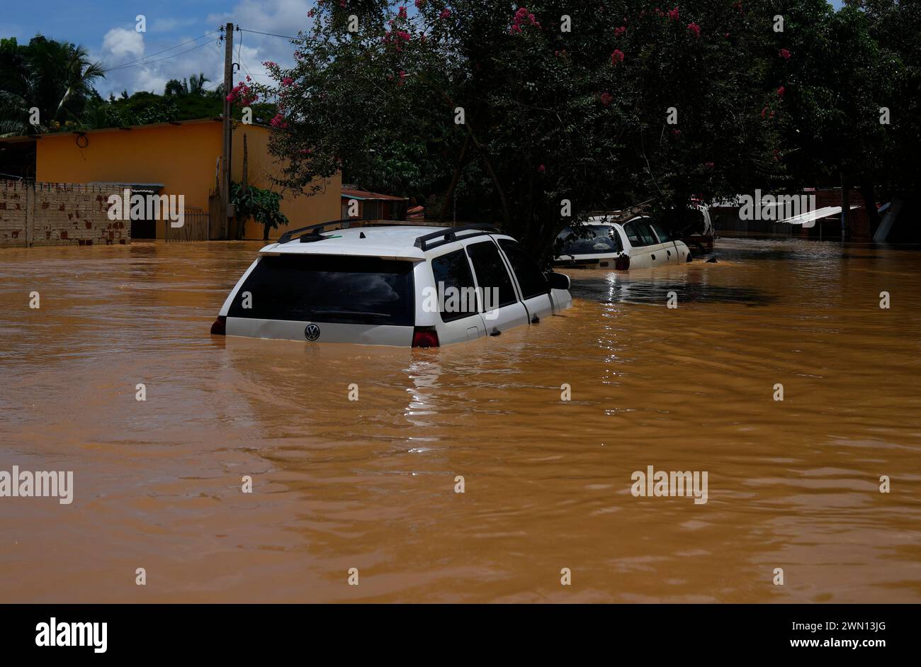 Cars are submerged in the flooded streets of Cobija, Bolivia, Wednesday ...